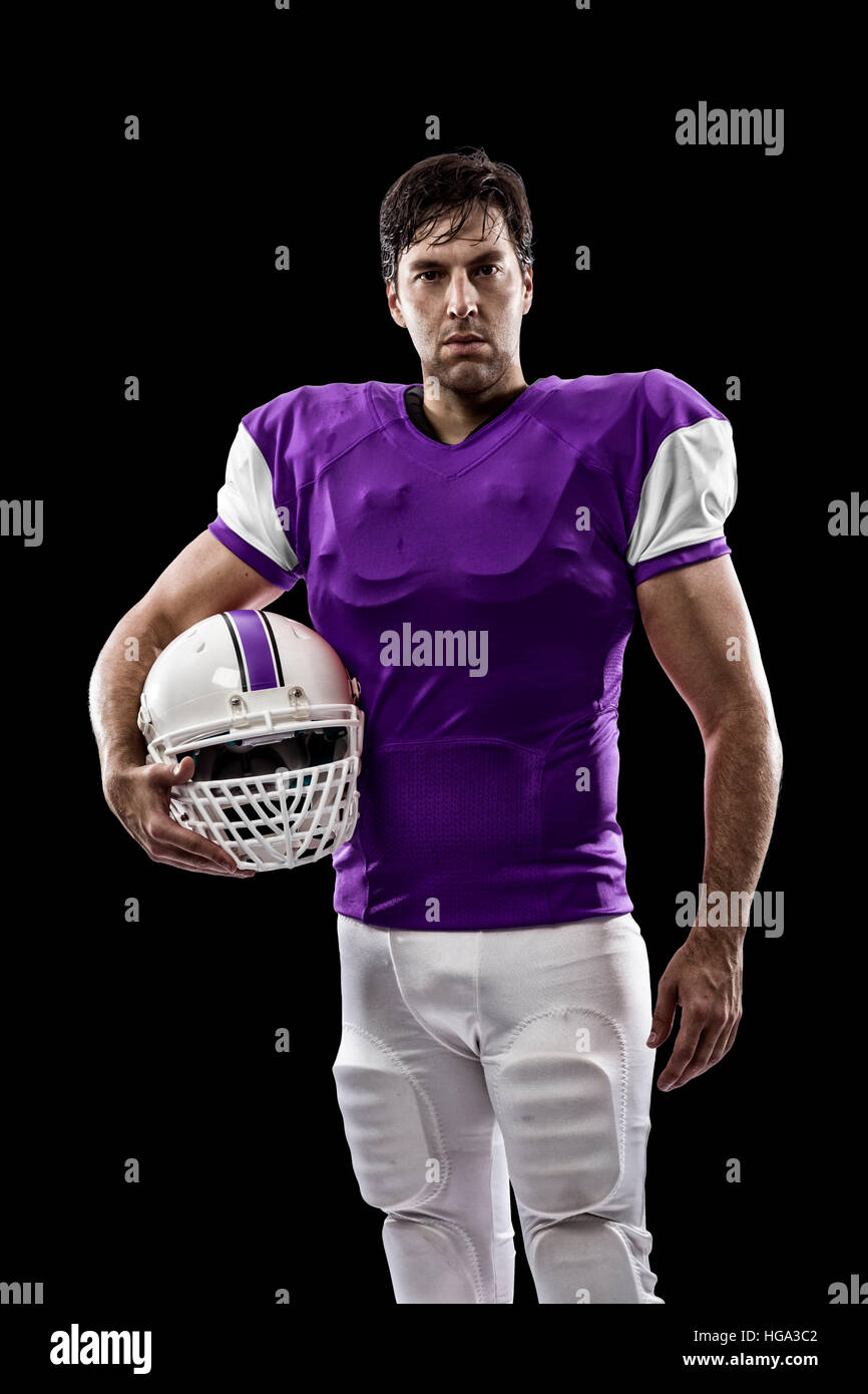 Football Player with a purple uniform on a black background Stock Photo ...
