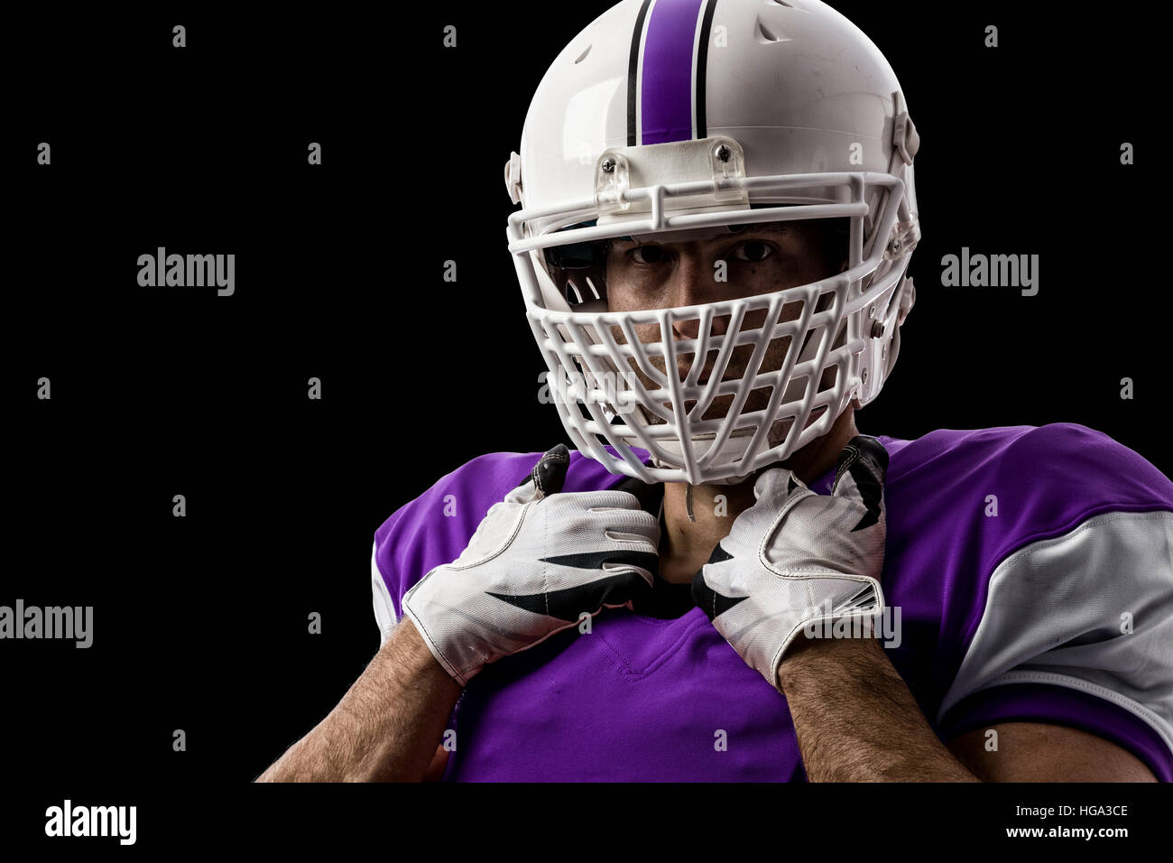 Football Player with a purple uniform on a black background Stock Photo ...