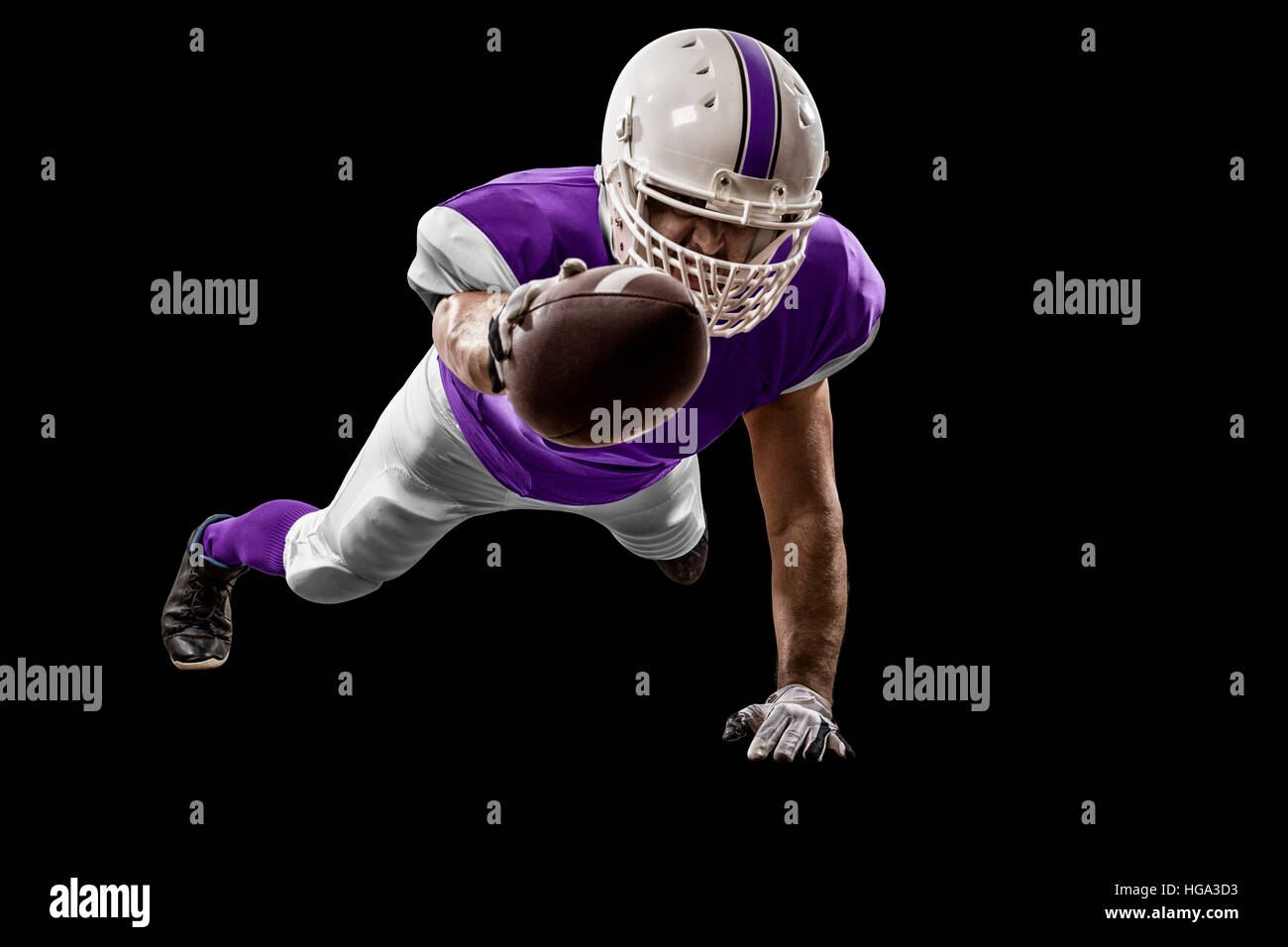 Football Player with a purple uniform scoring on a black background ...