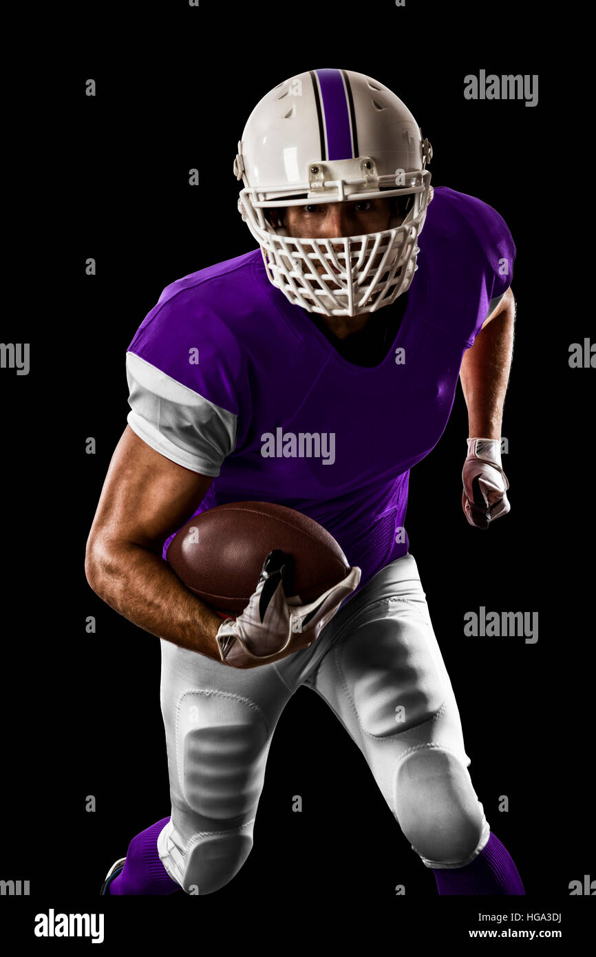 Football Player with a purple uniform Running on a black background ...