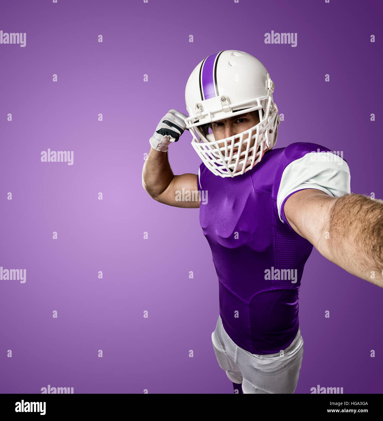 Football Player with a purple uniform making a selfie on a purple ...