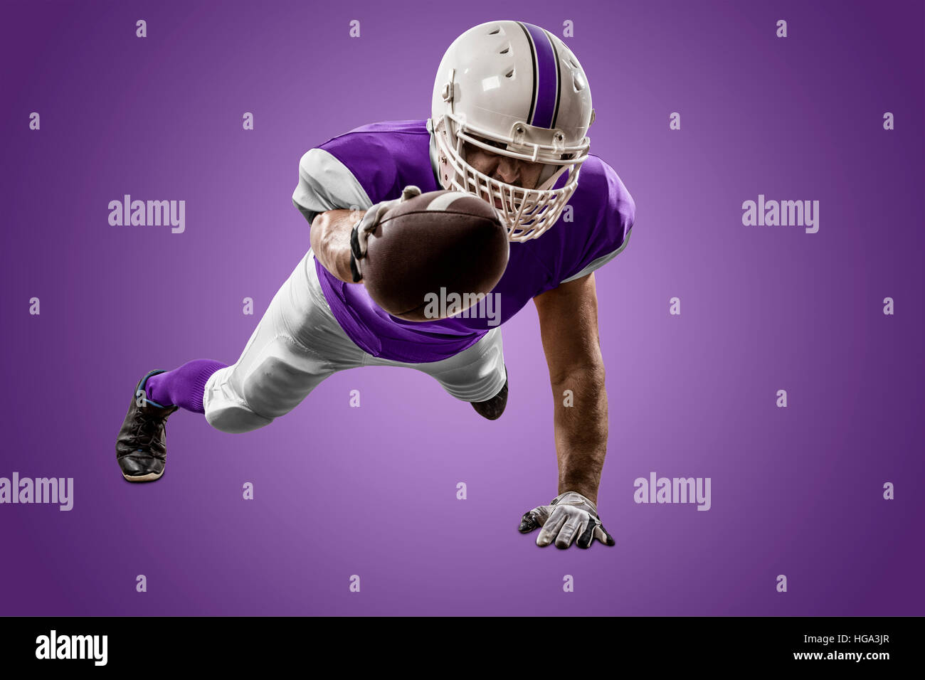 Football Player with a purple uniform scoring on a purple background ...