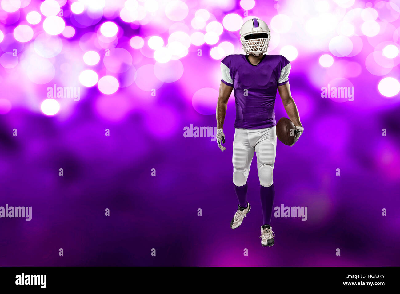 Football Player with a purple uniform on a purple lights background ...