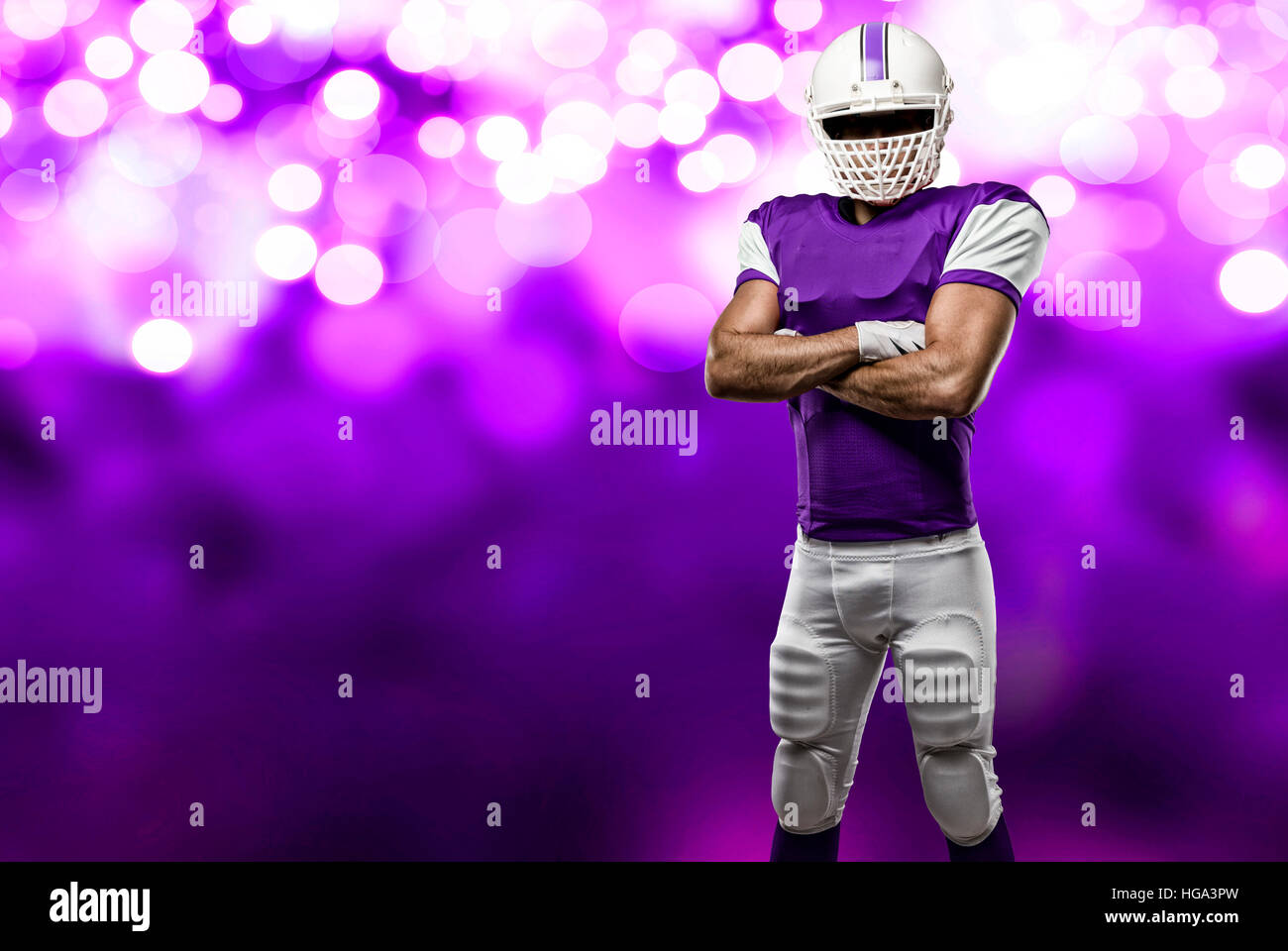 Football Player with a purple uniform on a purple lights background ...