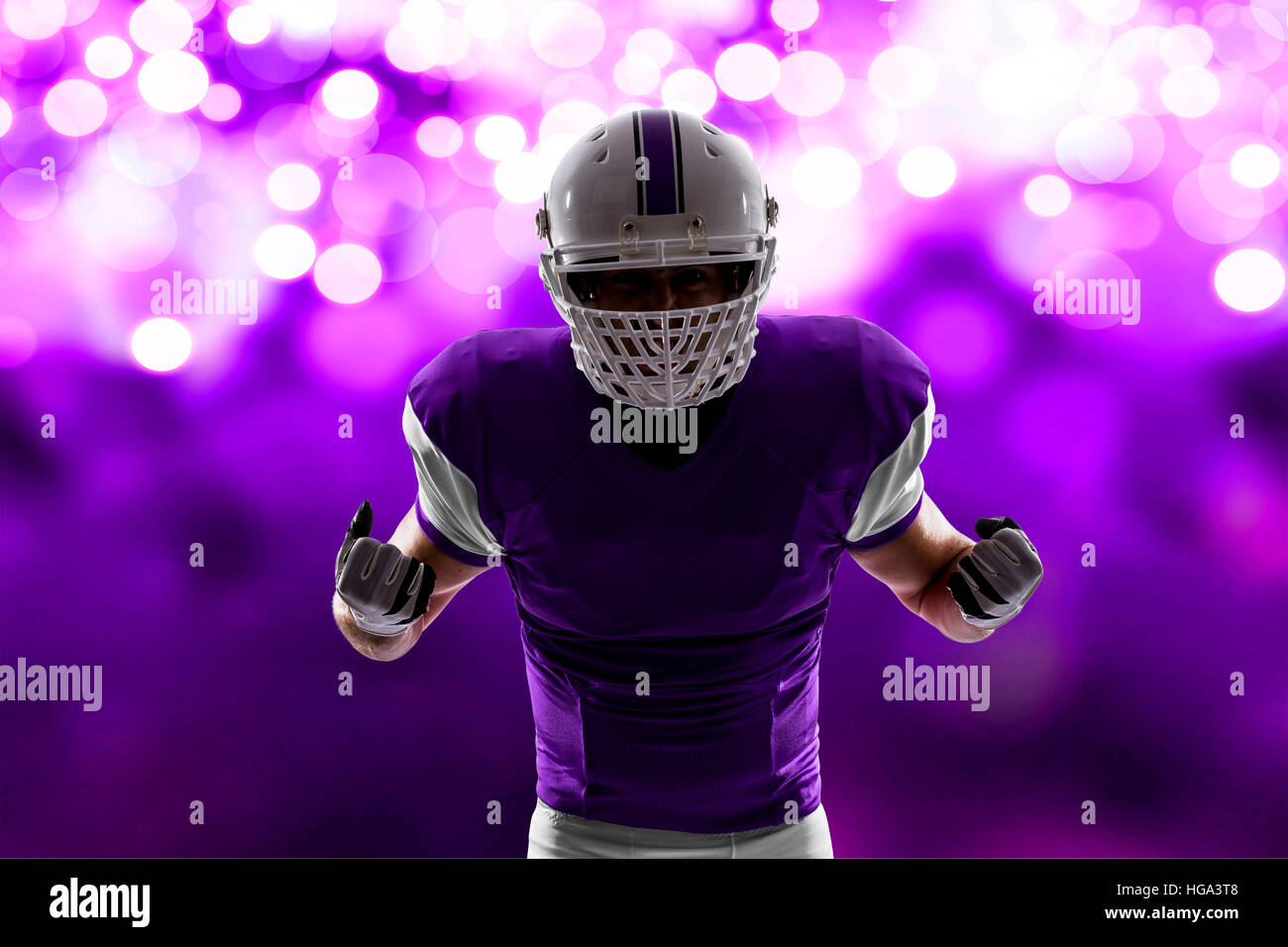 Football Player with a purple uniform on a purple lights background ...