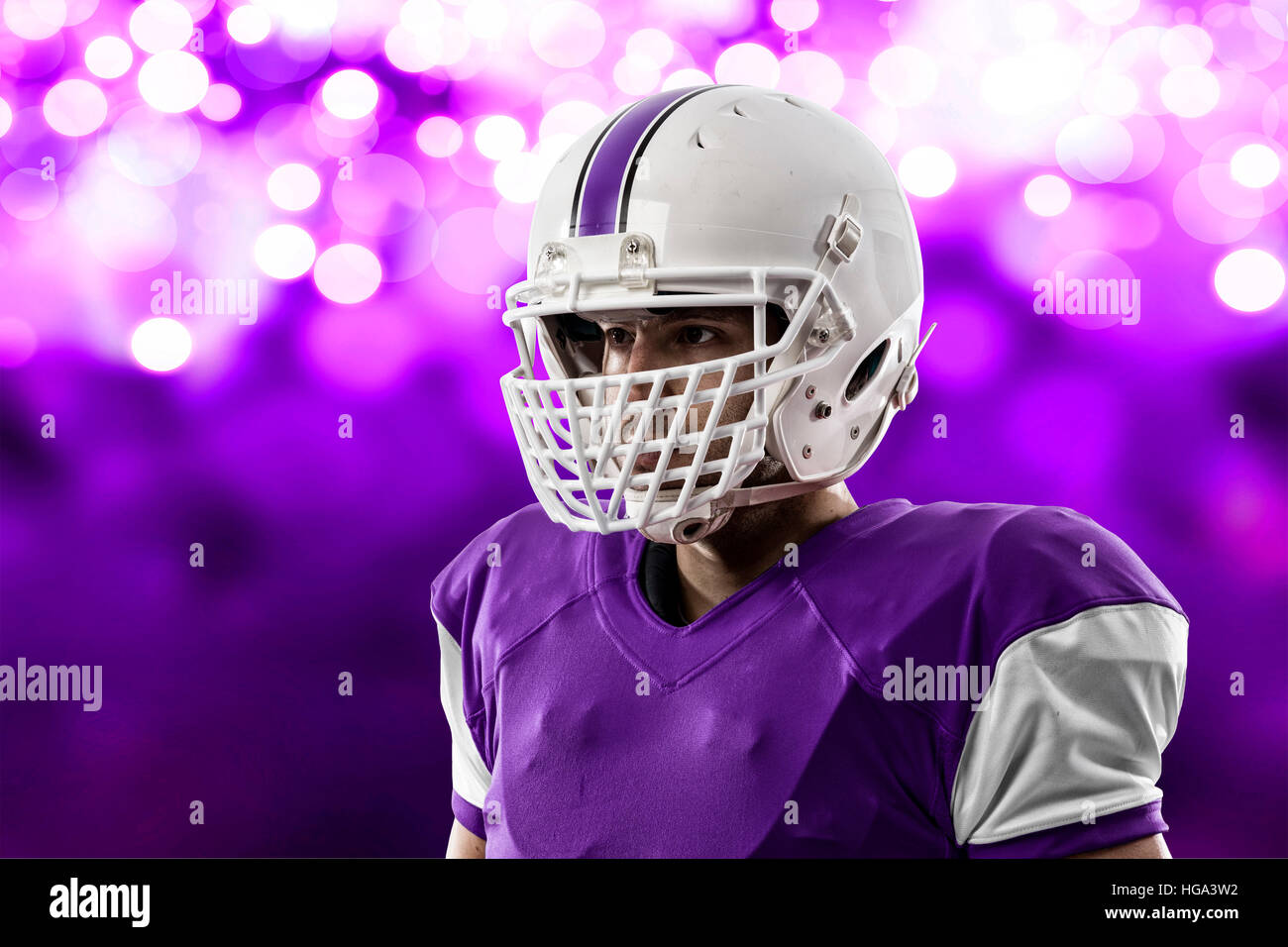 Close up of a Football Player with a purple uniform on a purple lights ...