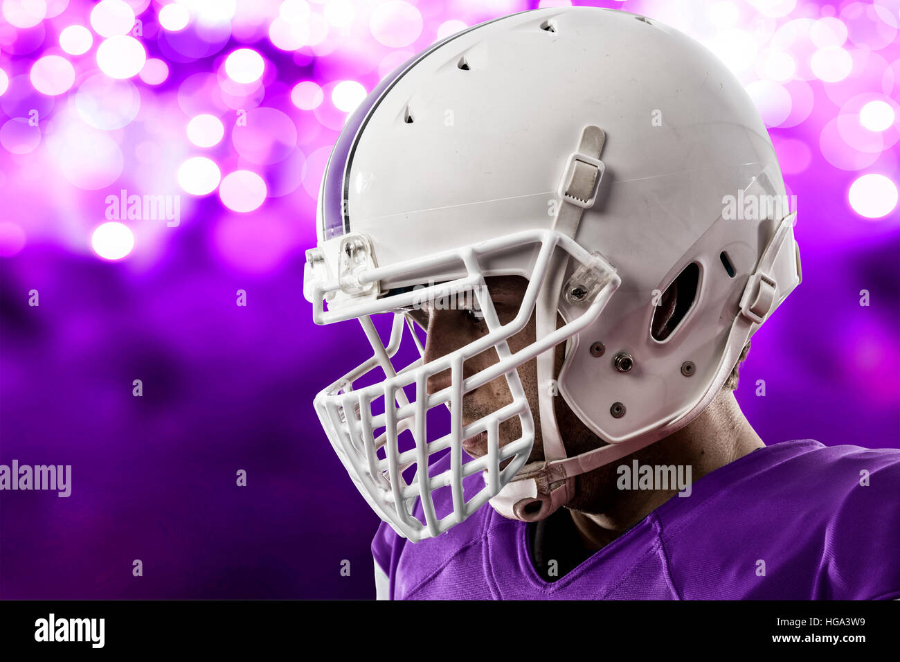 Close up of a Football Player with a purple uniform on a purple lights ...