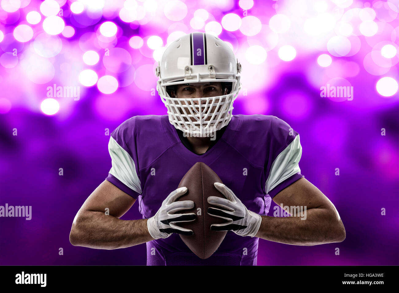 Football Player with a purple uniform on a purple lights background ...