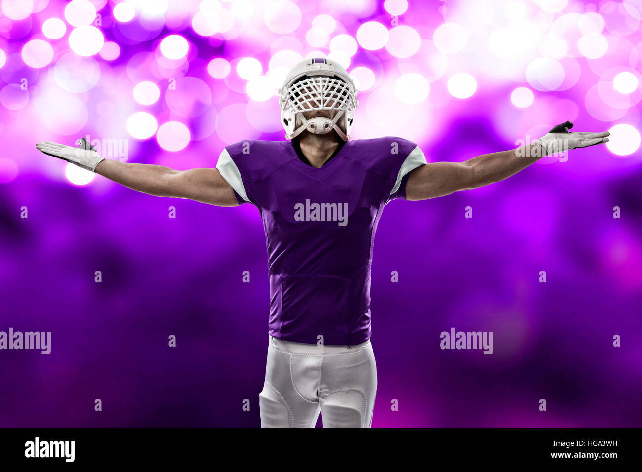 Football Player with a purple uniform celebrating, on a purple lights ...