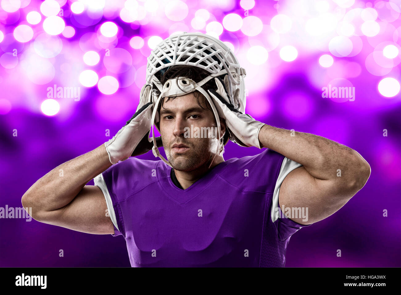 Football Player with a purple uniform on a purple lights background ...