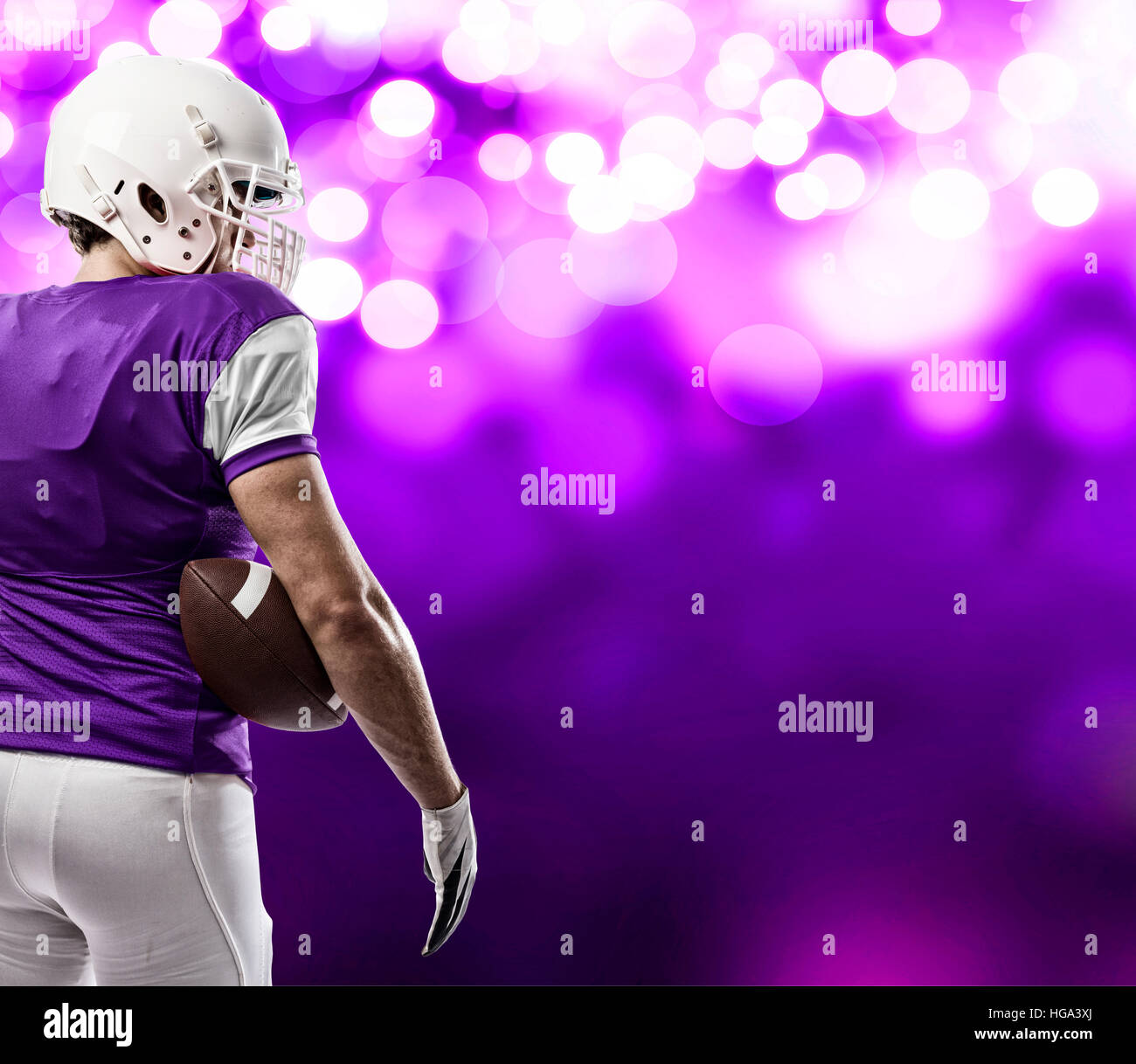 Football Player with a purple uniform on a purple lights background ...