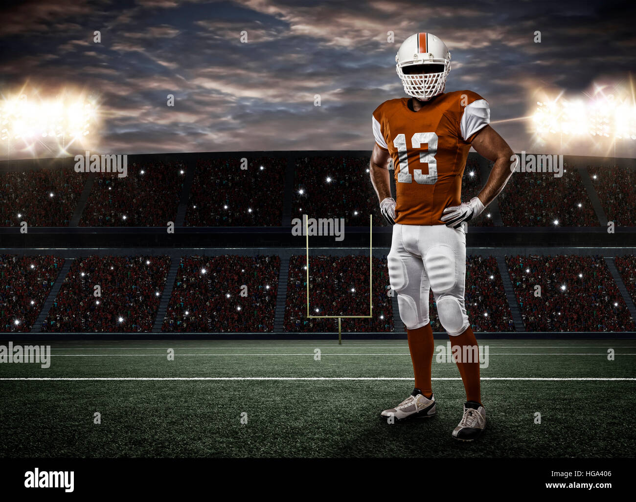 Football Player with a orange uniform on a stadium Stock Photo - Alamy