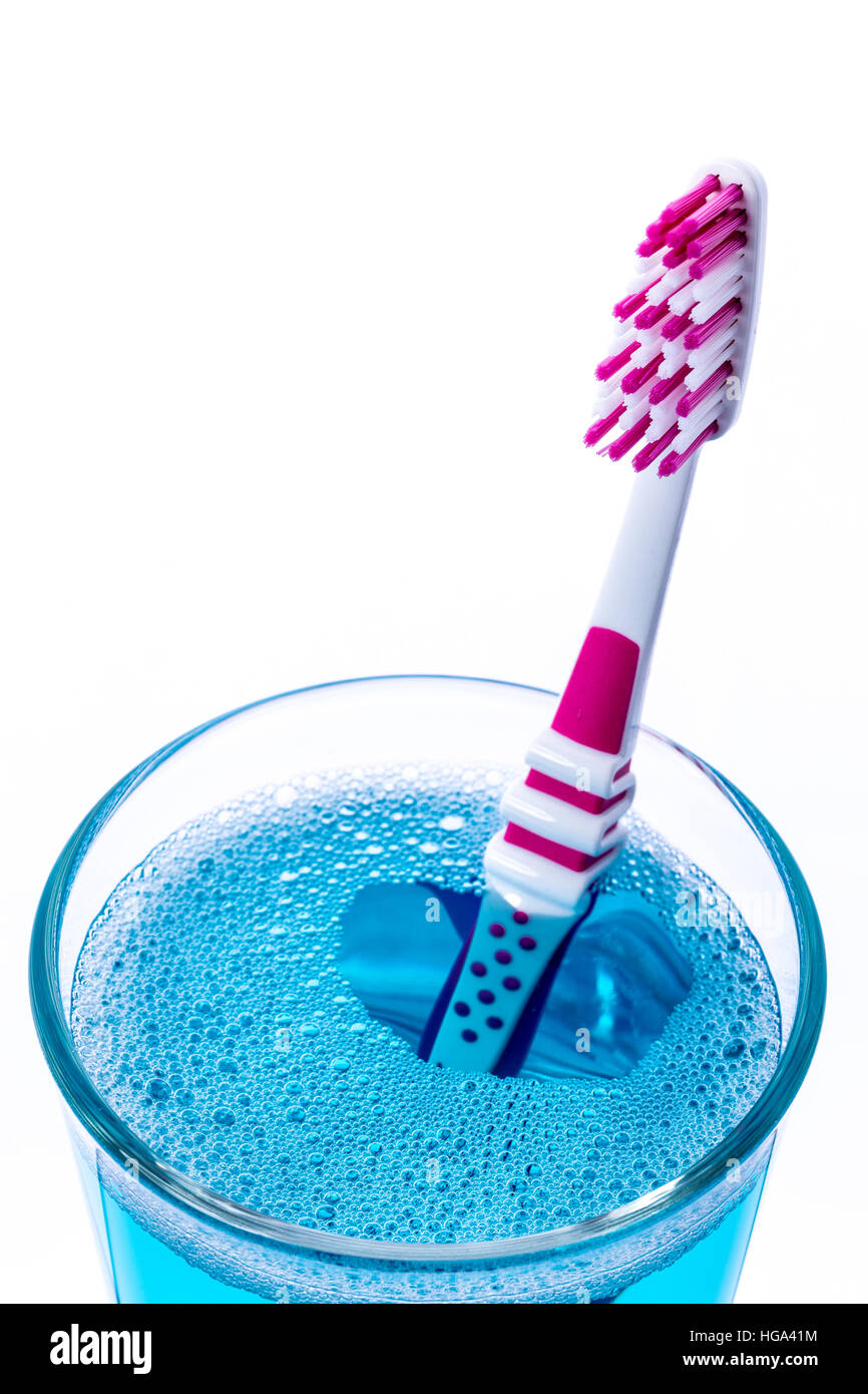 Toothbrush in glass with mouth rinse isolated on white, closeup Stock ...