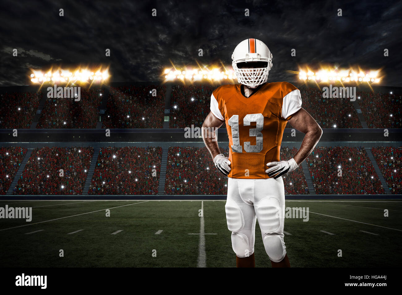 Football Player with a orange uniform on a stadium Stock Photo - Alamy