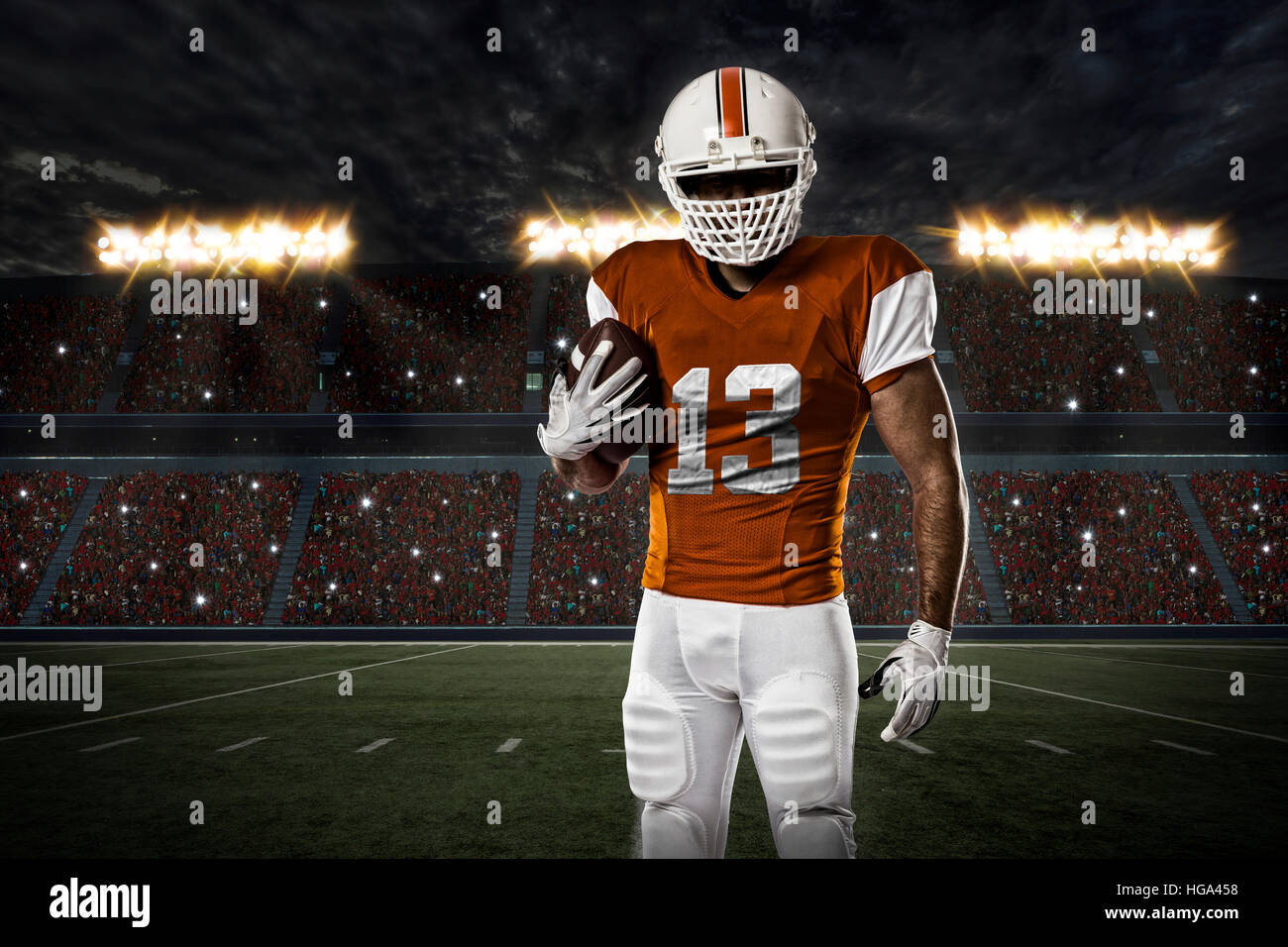 Football Player with a orange uniform on a stadium Stock Photo - Alamy