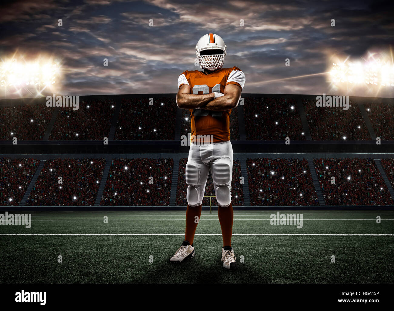Football Player with a orange uniform on a stadium Stock Photo - Alamy