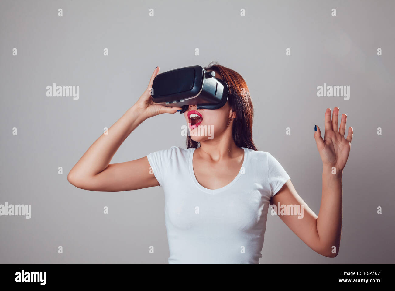 Attractive woman wearing virtual reality goggles. VR headset. Virtual ...