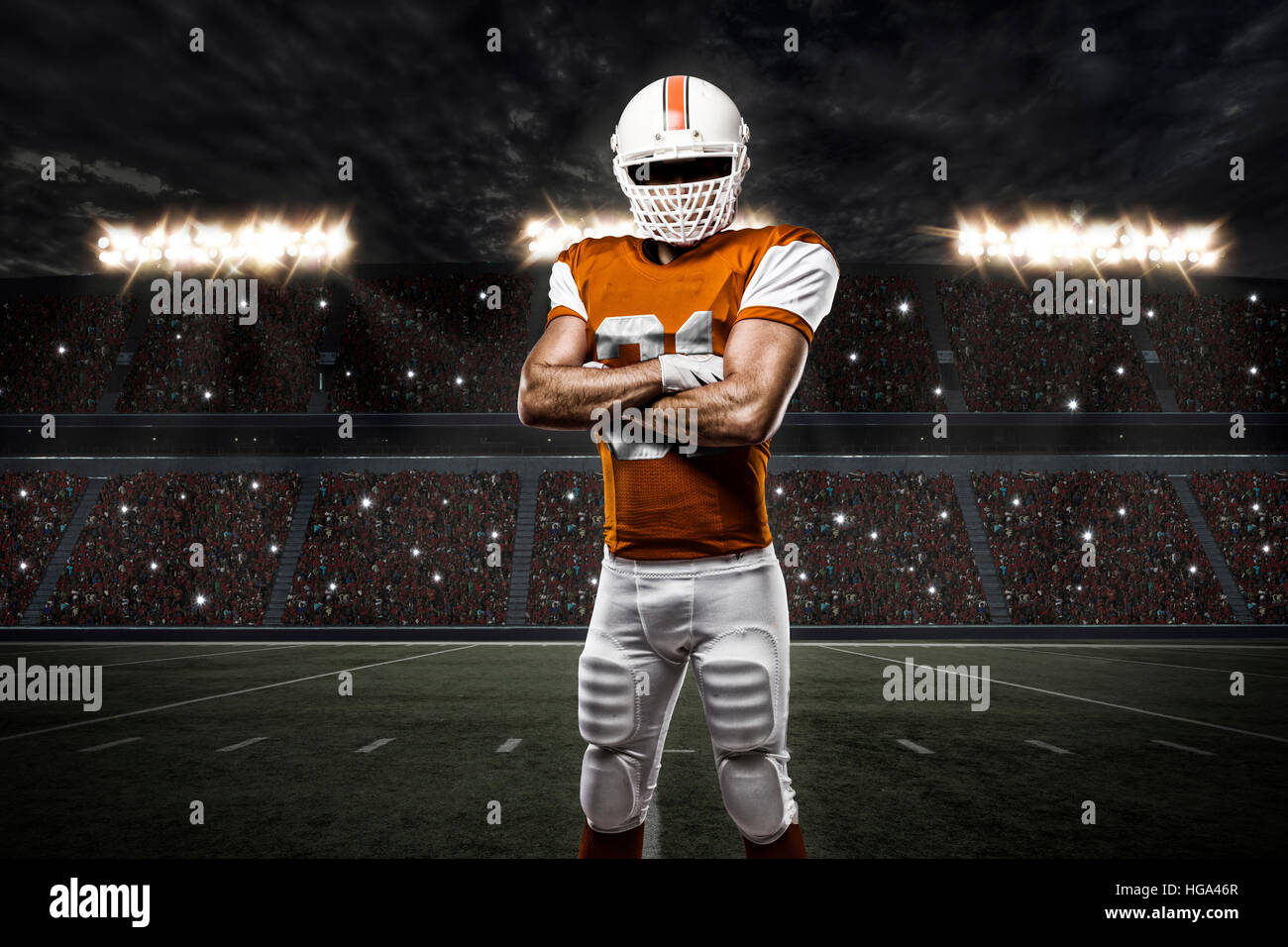 Football Player with a orange uniform on a stadium Stock Photo - Alamy
