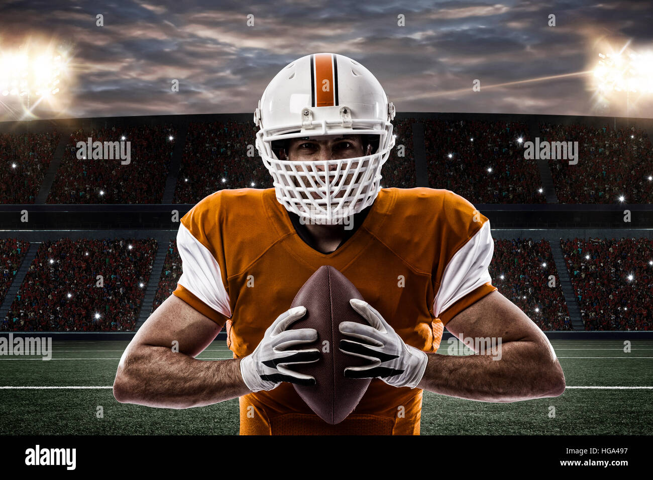 Football Player with a orange uniform on a stadium Stock Photo - Alamy