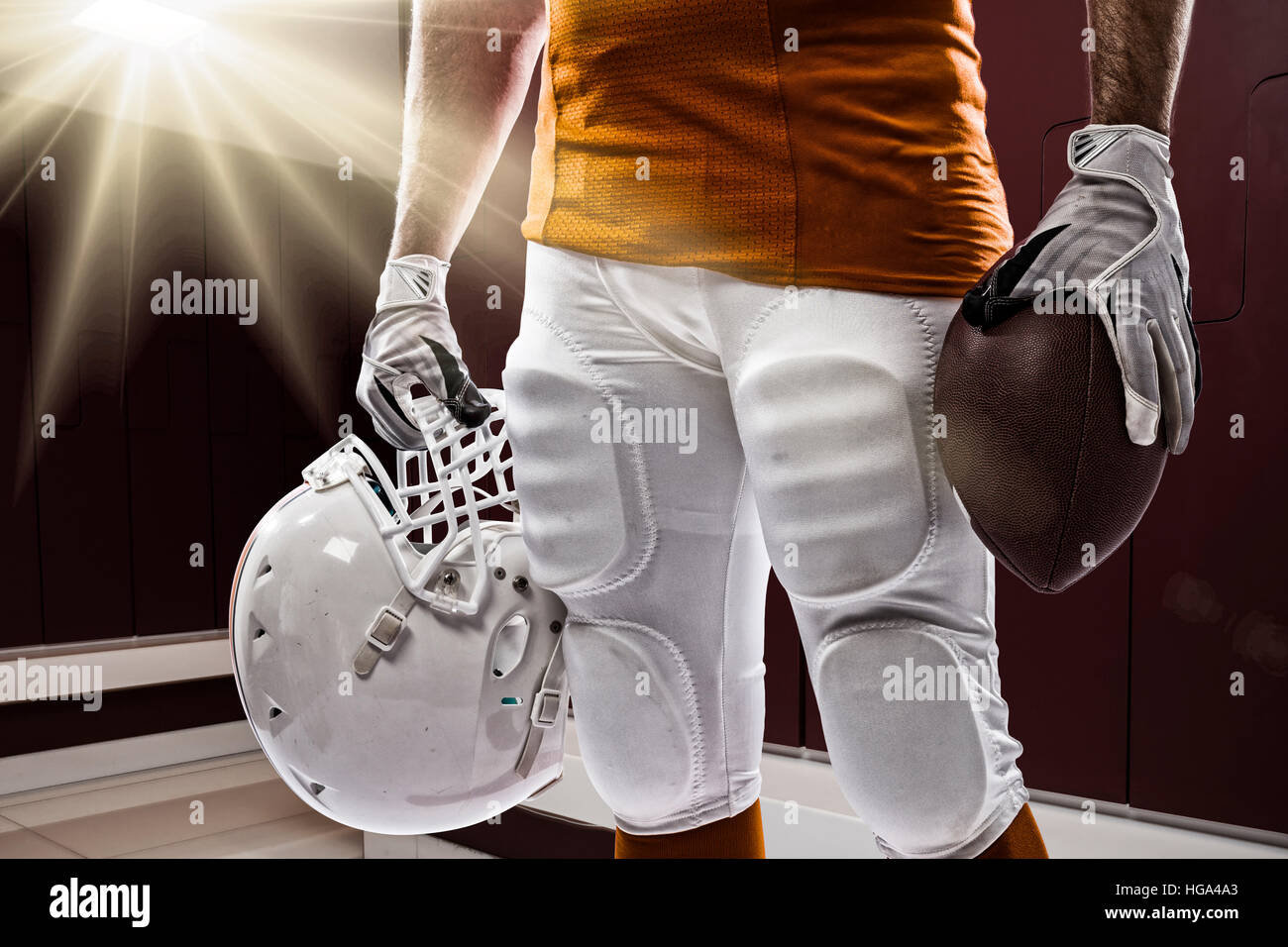 Football Player with a orange uniform on a Locker roon Stock Photo - Alamy