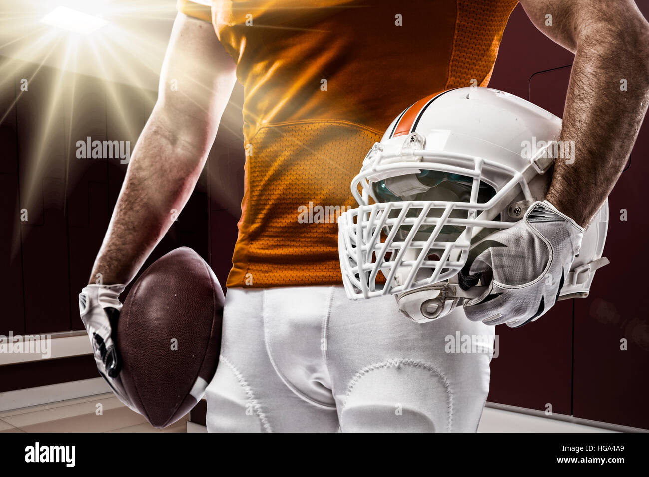 Football Player with a orange uniform on a Locker roon Stock Photo - Alamy