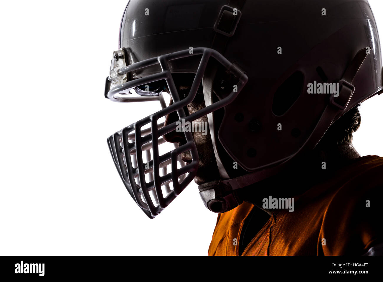 Close up of a Football Player with a orange uniform on a white ...
