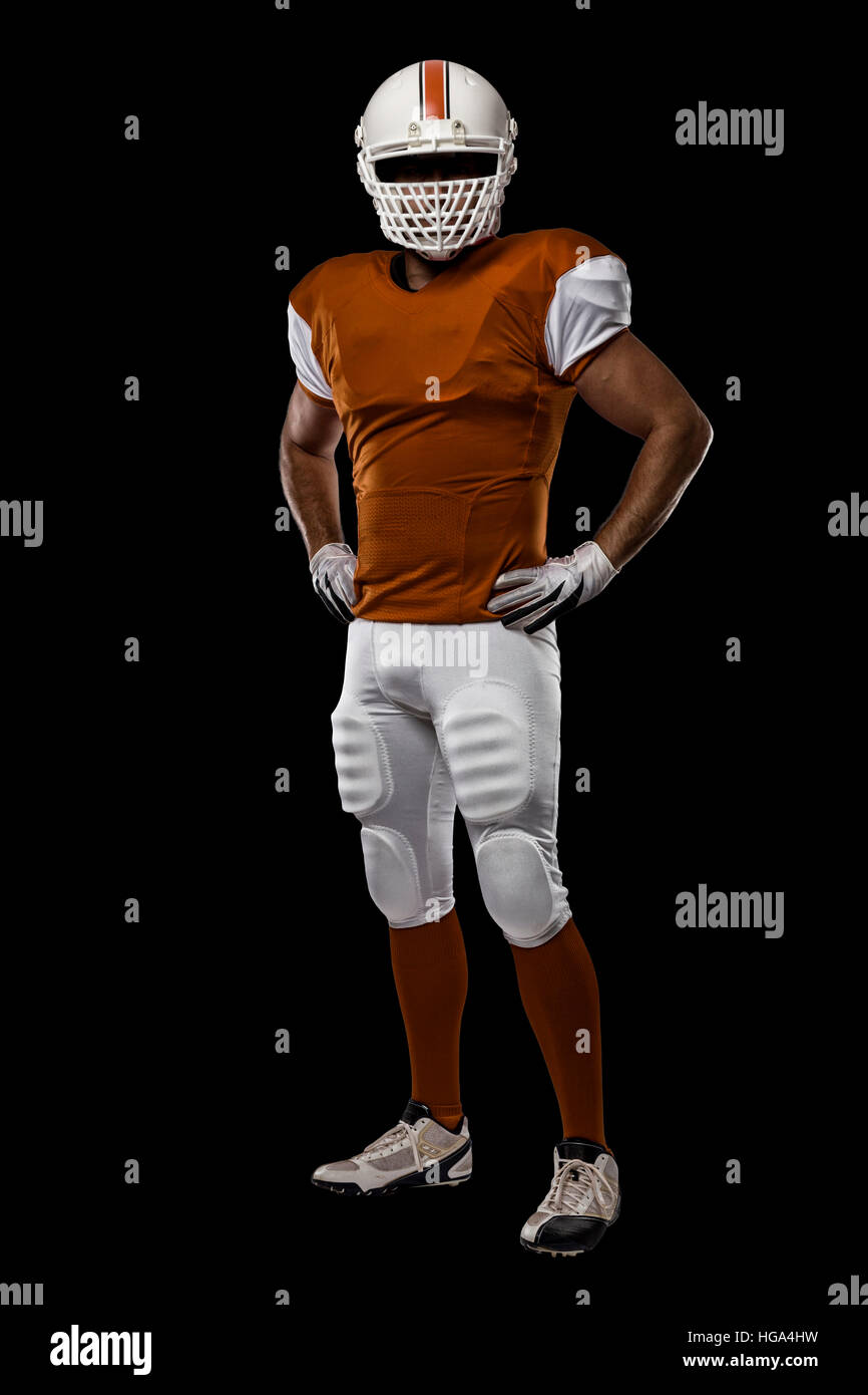 Football Player with a orange uniform on a black background Stock Photo ...
