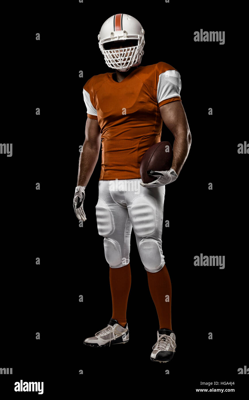Football Player with a orange uniform on a black background Stock Photo ...