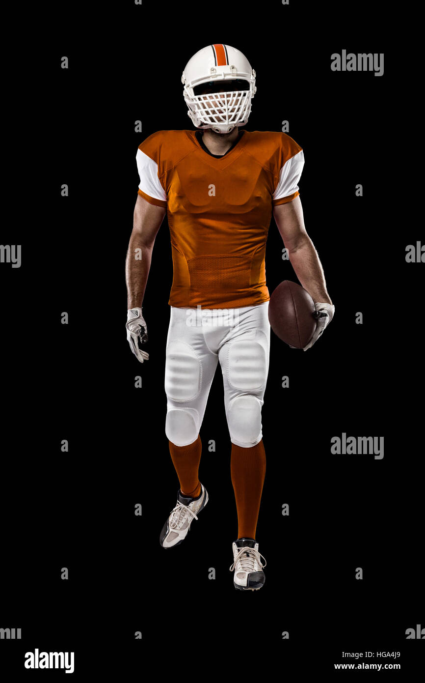 Football Player with a orange uniform on a black background Stock Photo ...