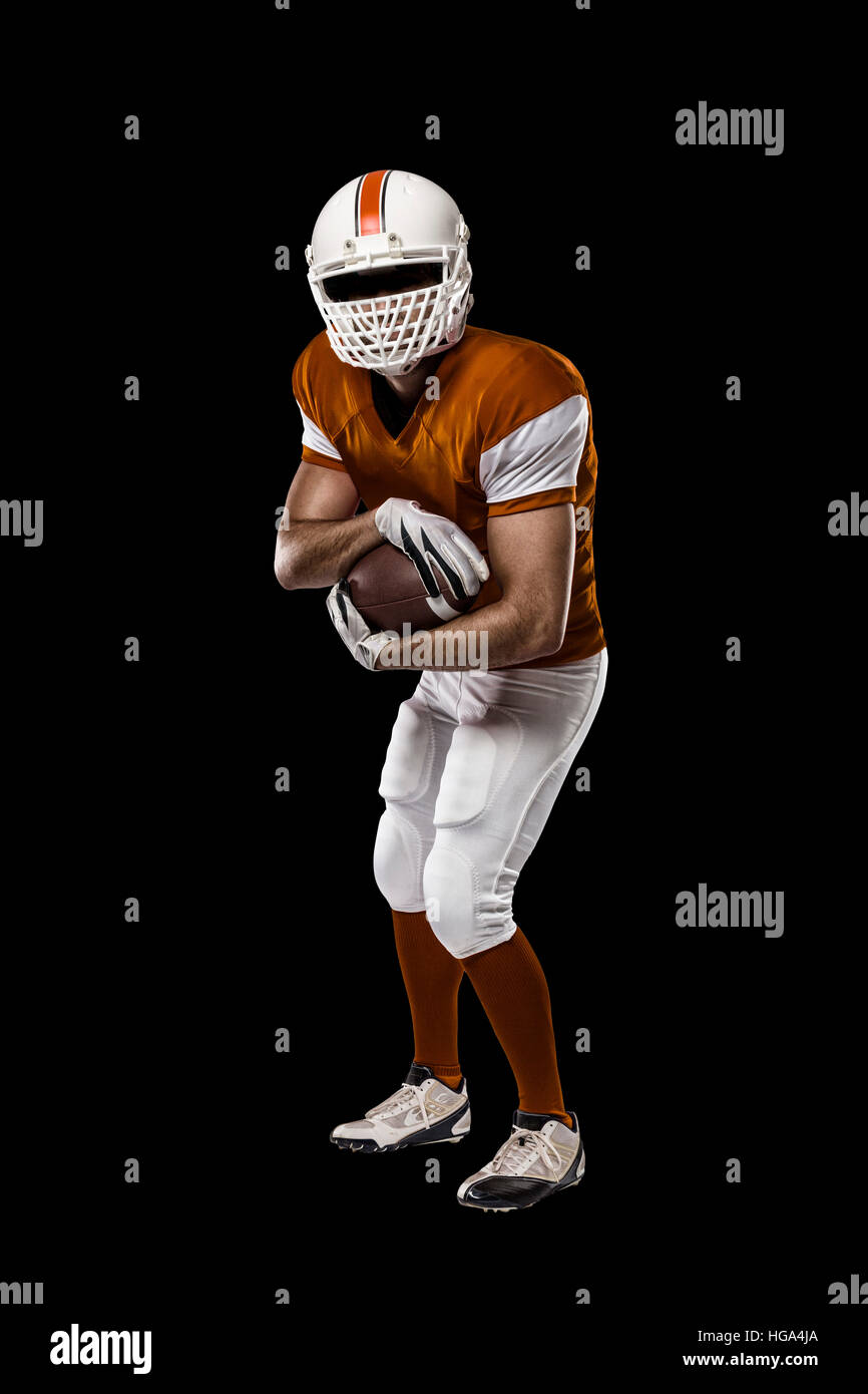 Football Player with a orange uniform on a black background Stock Photo ...
