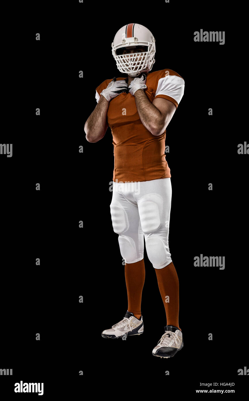 Football Player with a orange uniform on a black background Stock Photo ...