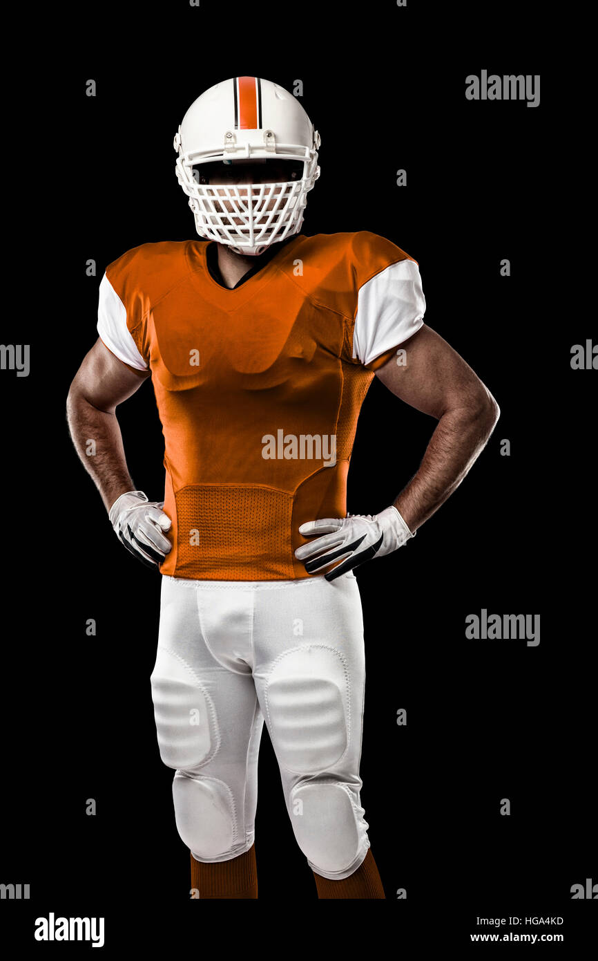 Football Player with a orange uniform on a black background Stock Photo ...
