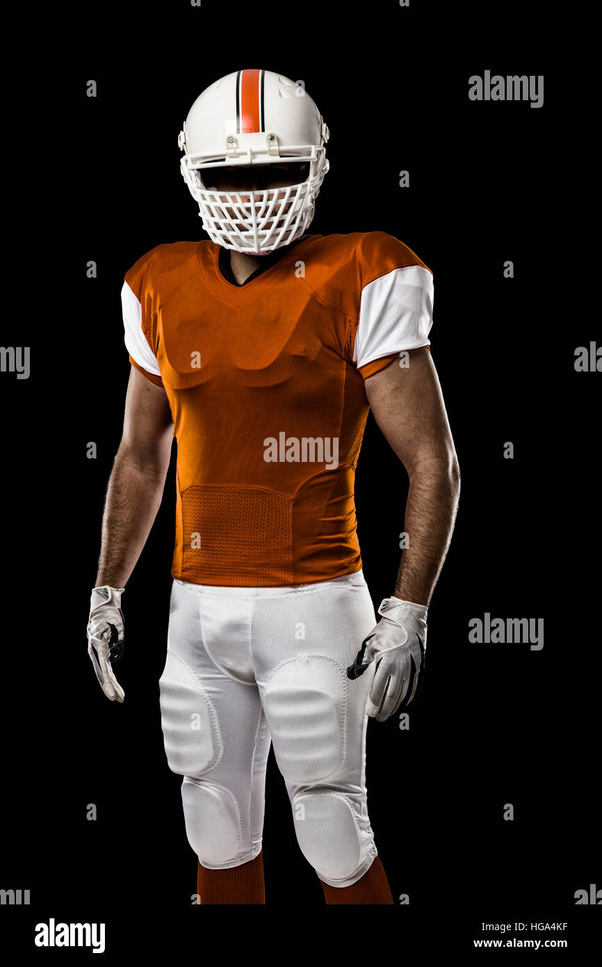 Football Player with a orange uniform on a black background Stock Photo ...
