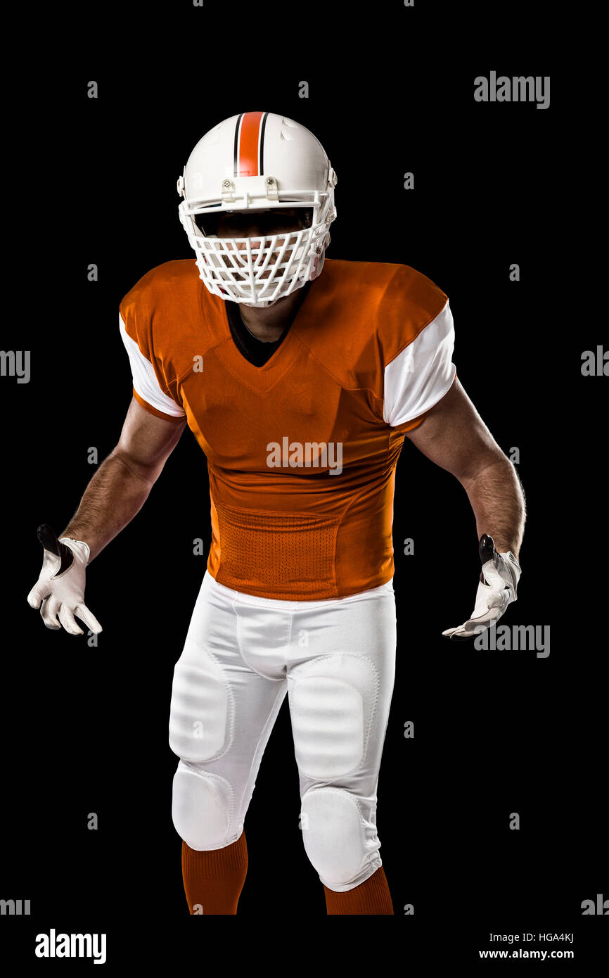 Football Player with a orange uniform on a black background Stock Photo ...
