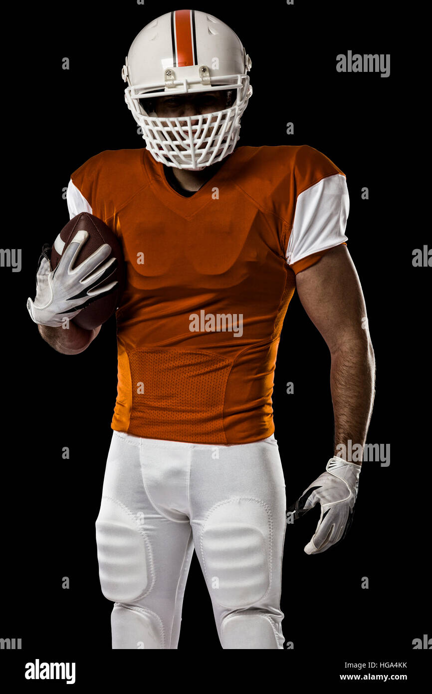 Football Player with a orange uniform on a black background Stock Photo ...