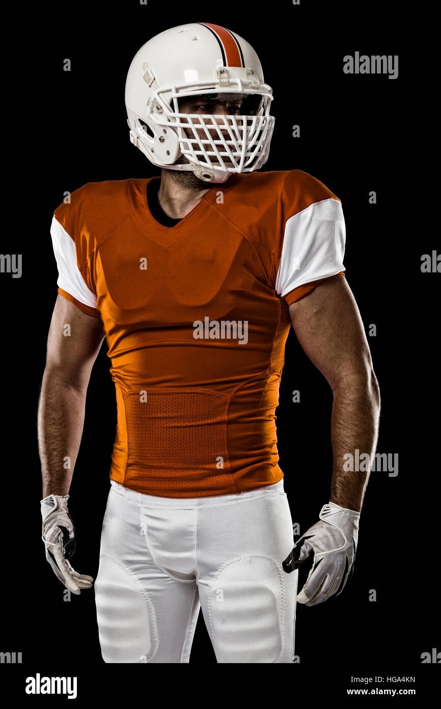 Football Player with a orange uniform on a black background Stock Photo ...