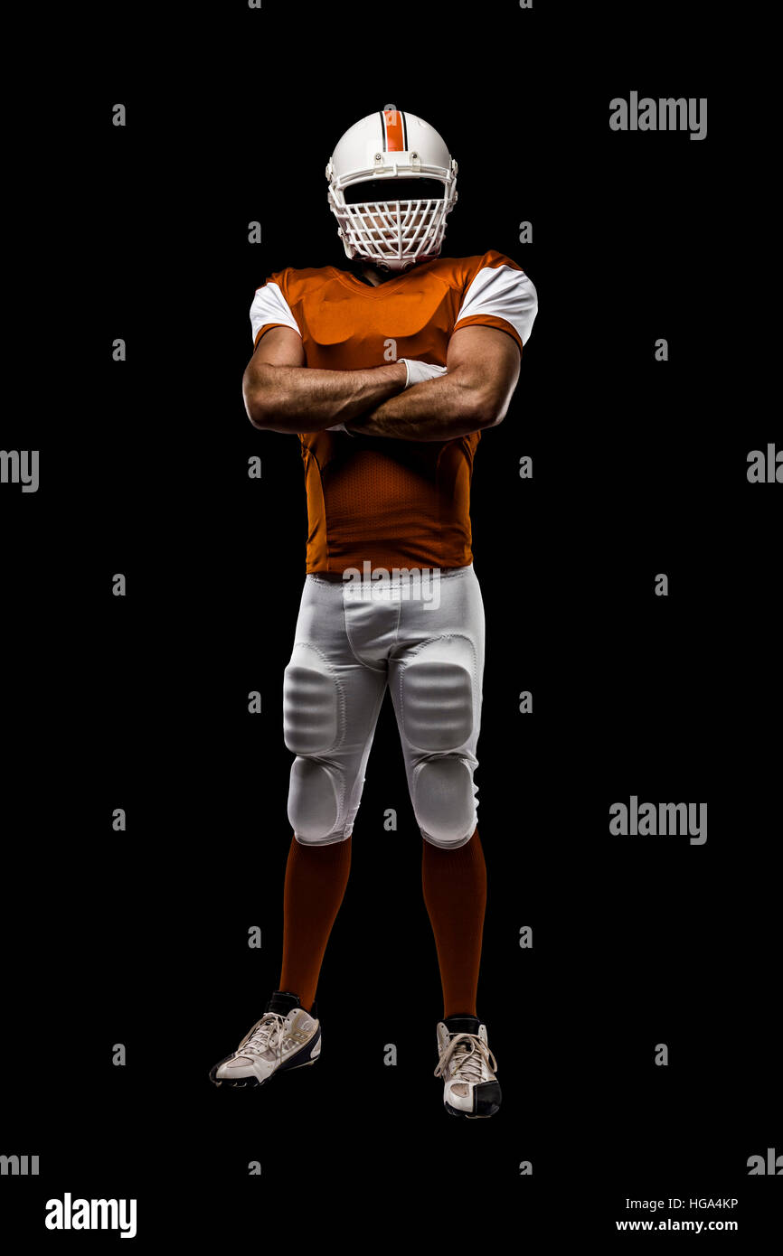 Football Player with a orange uniform on a black background Stock Photo ...