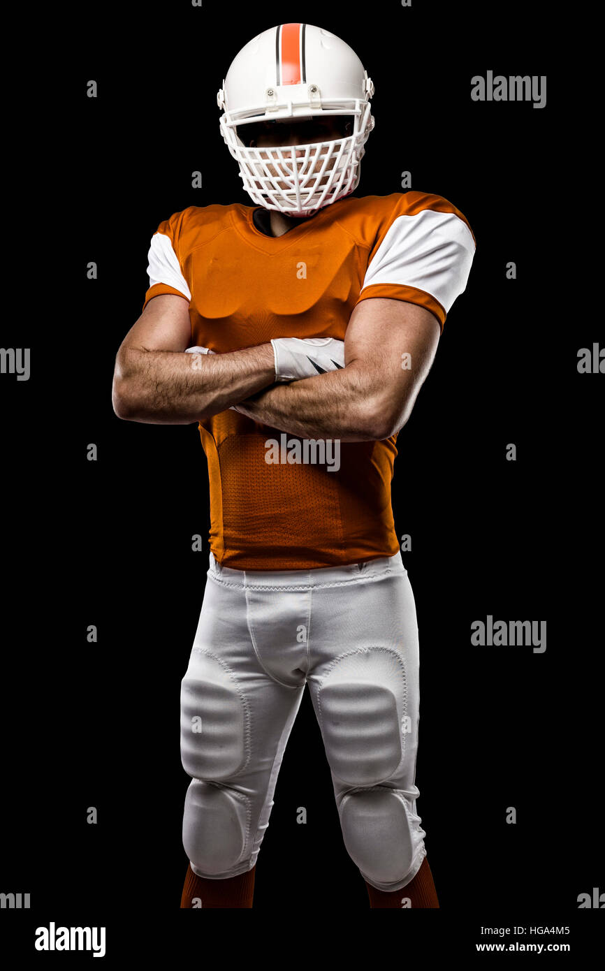 Football Player with a orange uniform on a black background Stock Photo ...