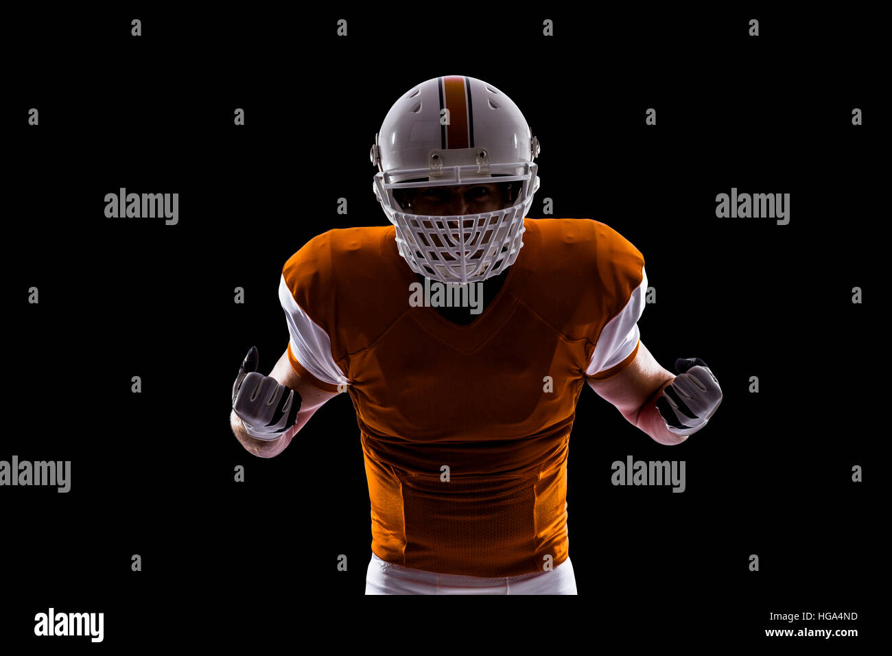 Football Player with a orange uniform on a black background Stock Photo ...