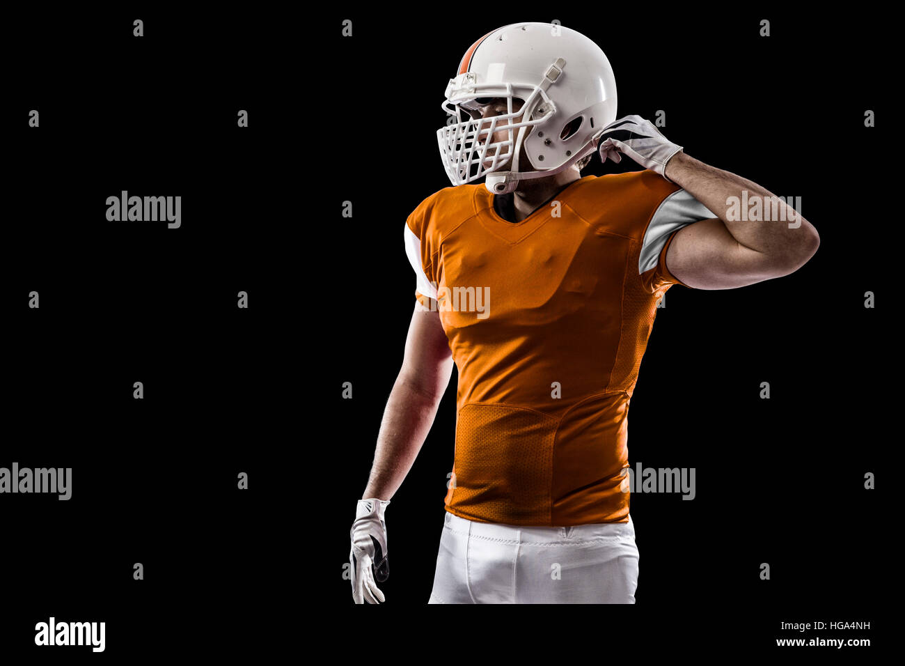 Football Player with a orange uniform on a black background Stock Photo ...