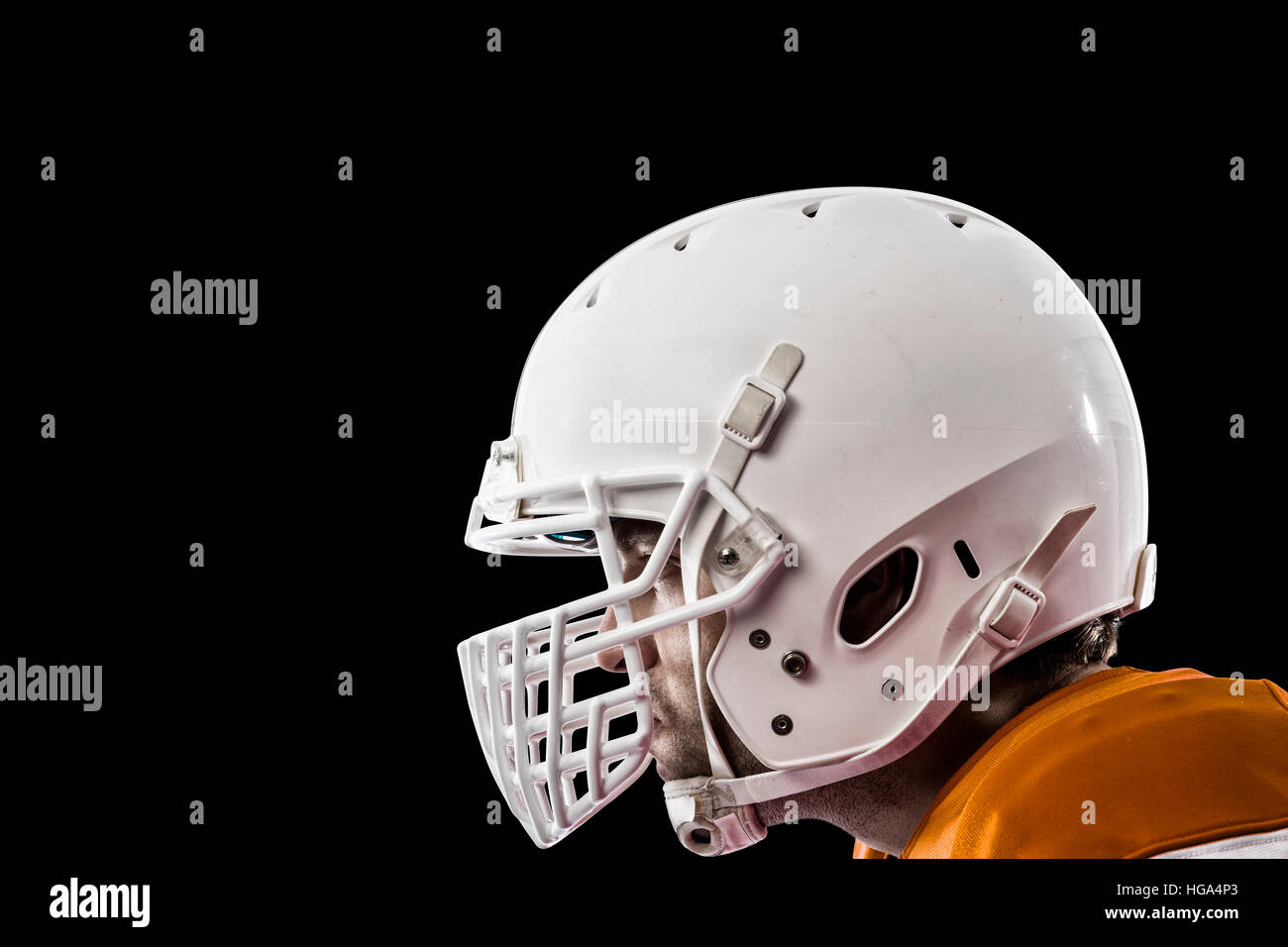 Close up of a Football Player with a orange uniform on a black ...