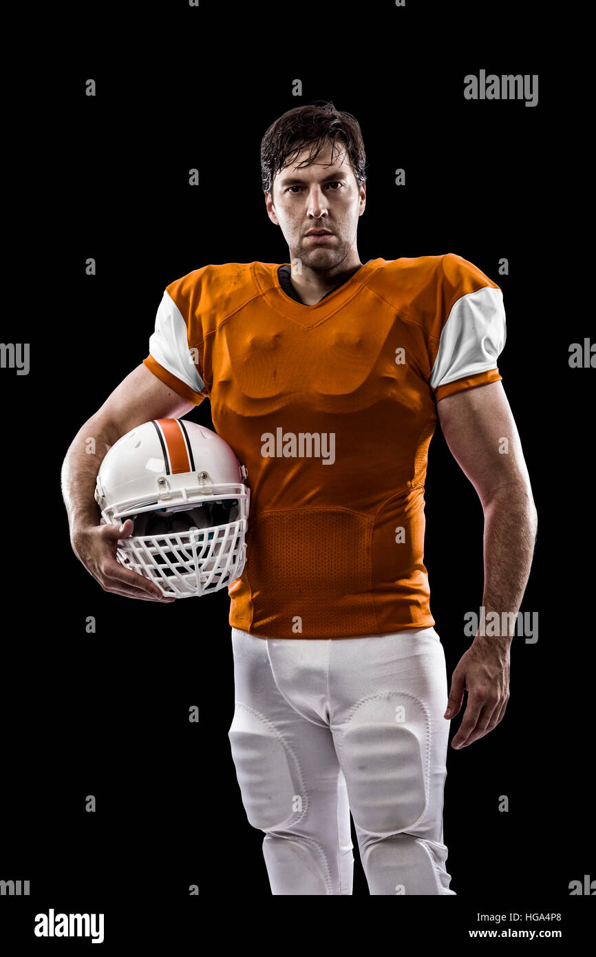 Football Player with a orange uniform on a black background Stock Photo ...