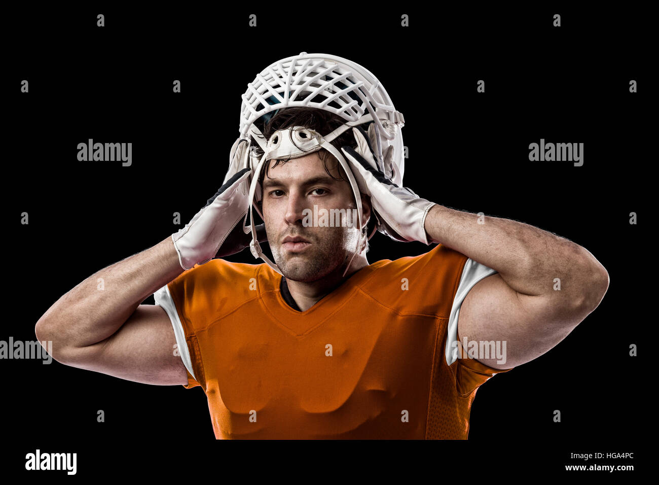 Football Player with a orange uniform on a black background Stock Photo ...