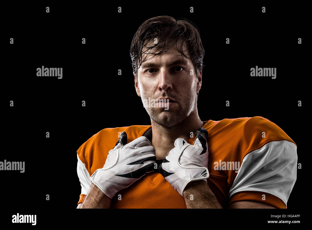 Football Player with a orange uniform on a black background Stock Photo ...