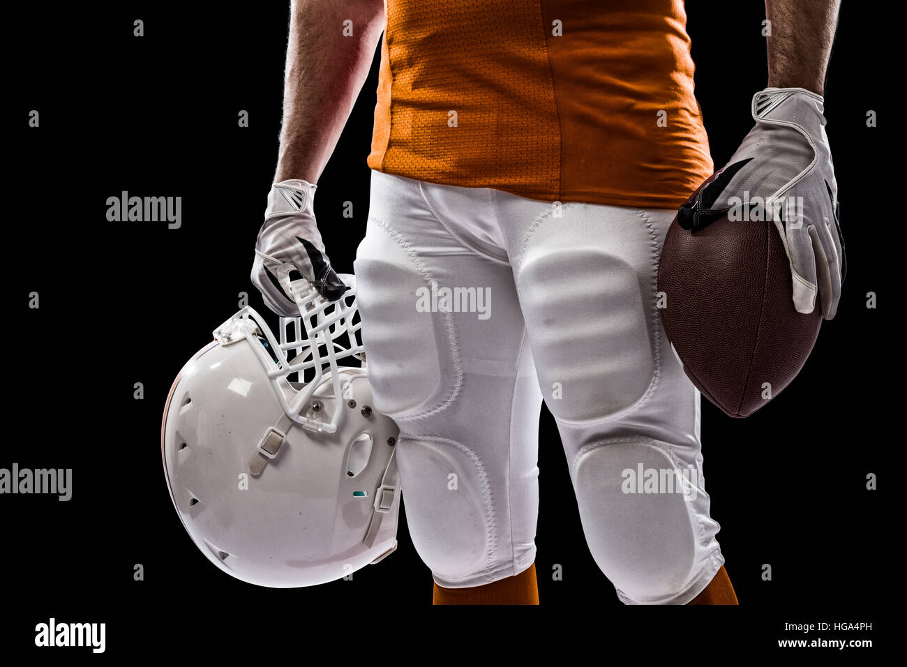 Football Player with a orange uniform on a black background Stock Photo ...