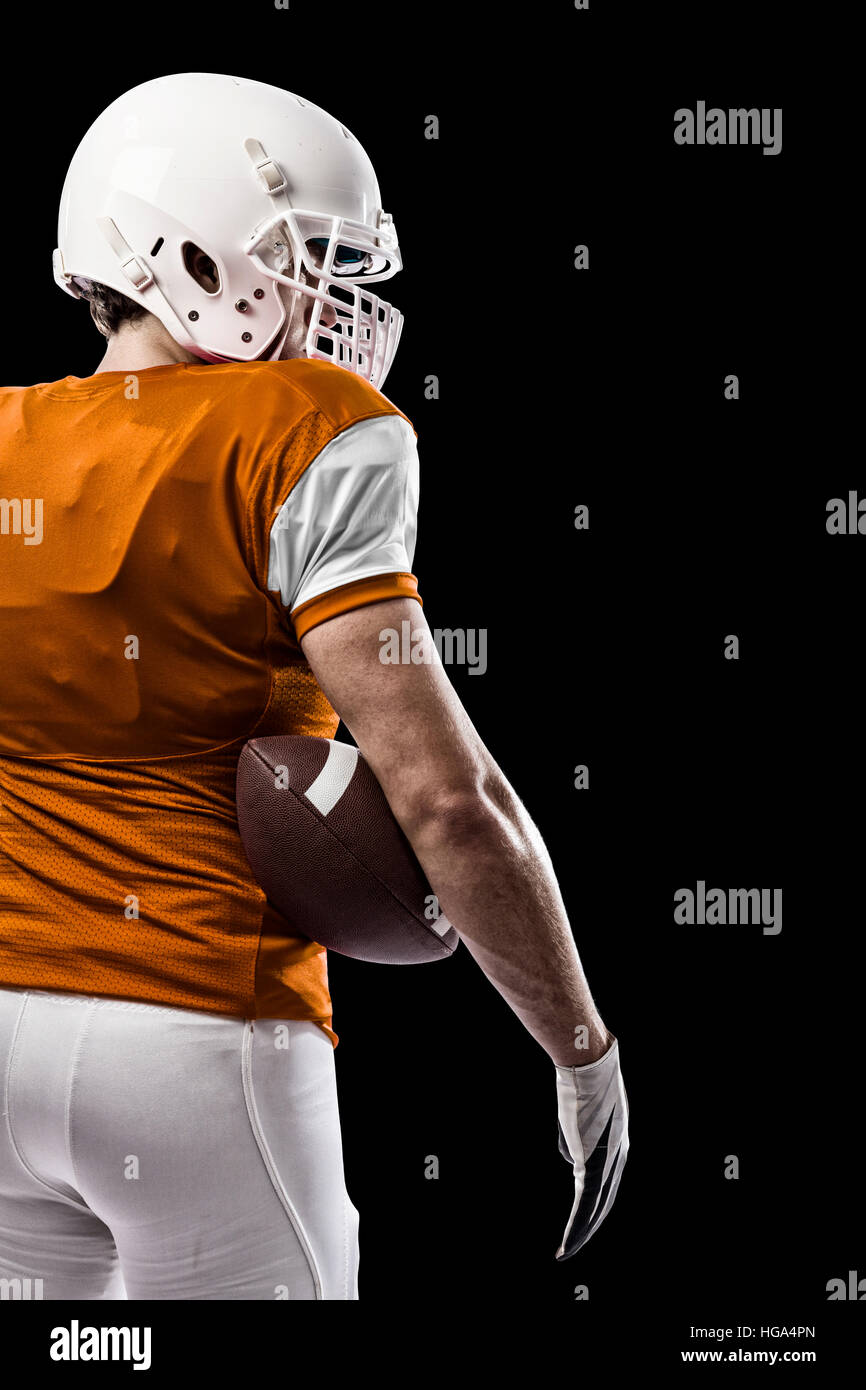 Football Player with a orange uniform on a black background Stock Photo ...