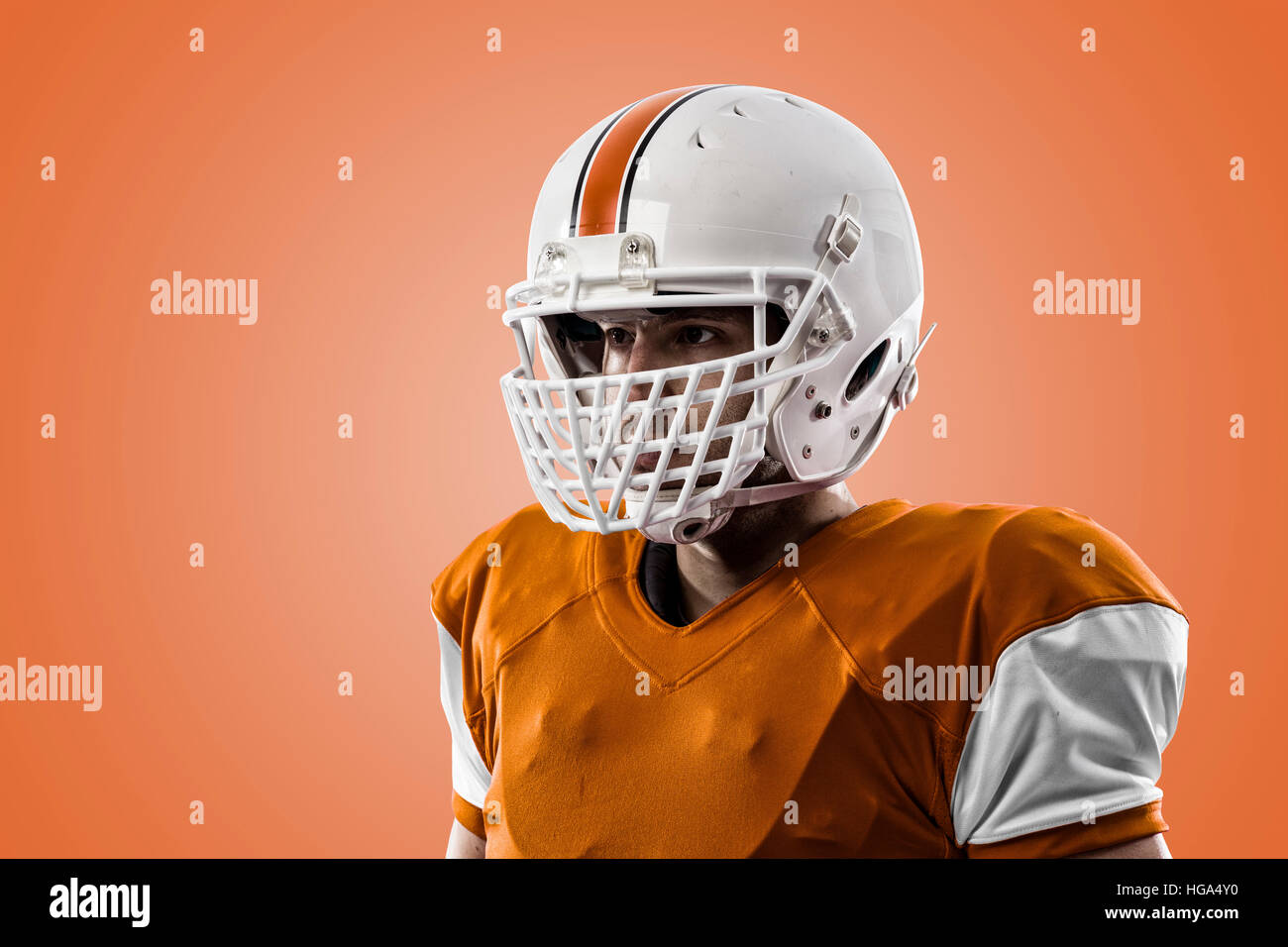 Close up of a Football Player with a orange uniform on a orange ...