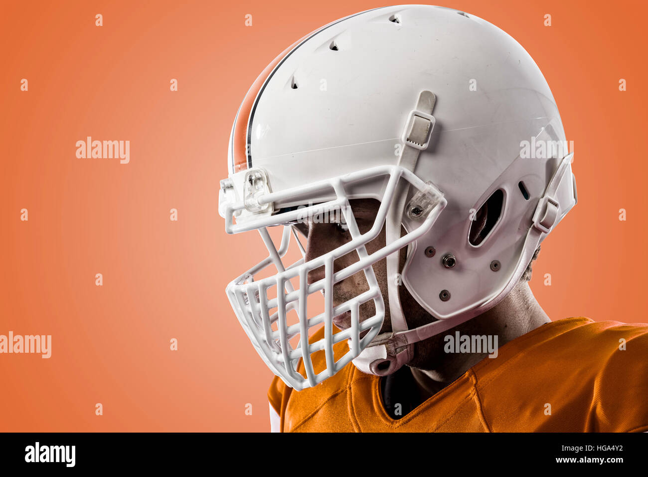Close up of a Football Player with a orange uniform on a orange ...