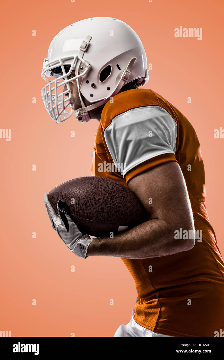 Football Player with a orange uniform Running on a orange background ...