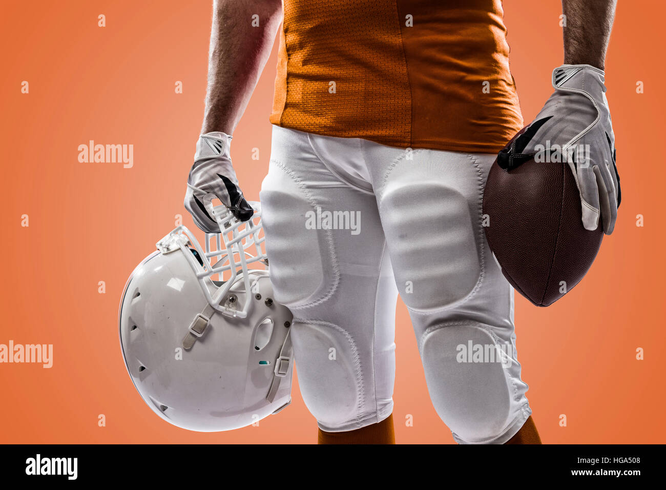 Football Player with a orange uniform on a orange background Stock ...